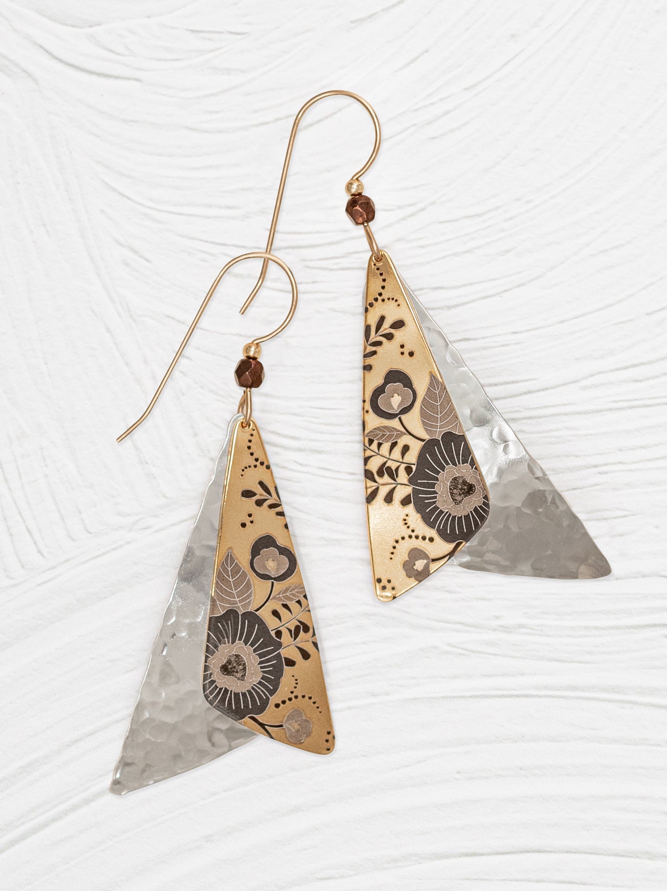 The Forever Flutter Earrings feature signature Holly Yashi detailing and hand-hammered metal.